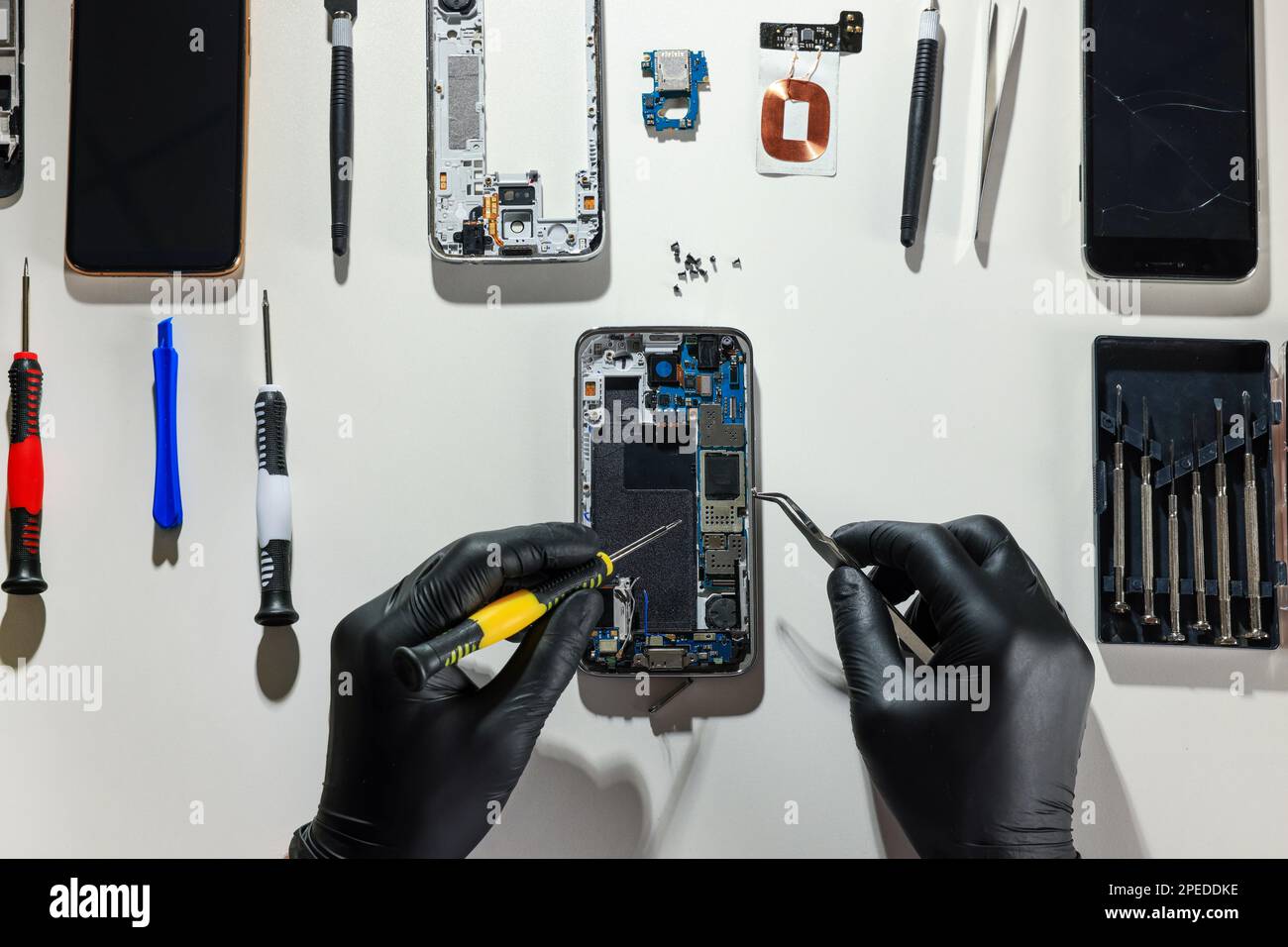 Technician repairing broken smartphone at white table, top view Stock ...