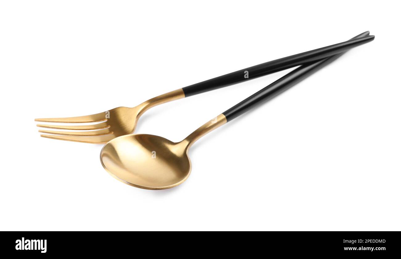 New golden fork and spoon with black handles on white background Stock ...