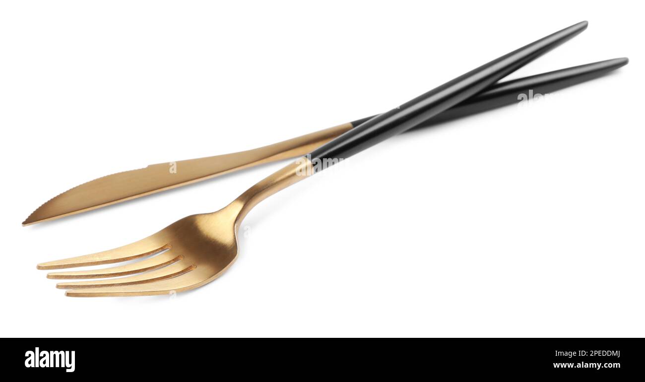 New golden fork and knife with black handles on white background Stock ...