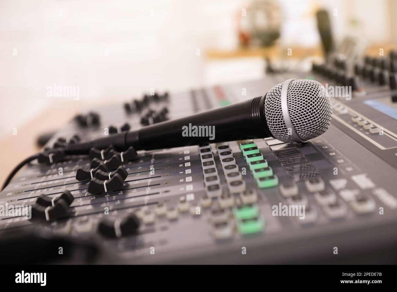 Microphone on professional mixing console in modern radio studio ...