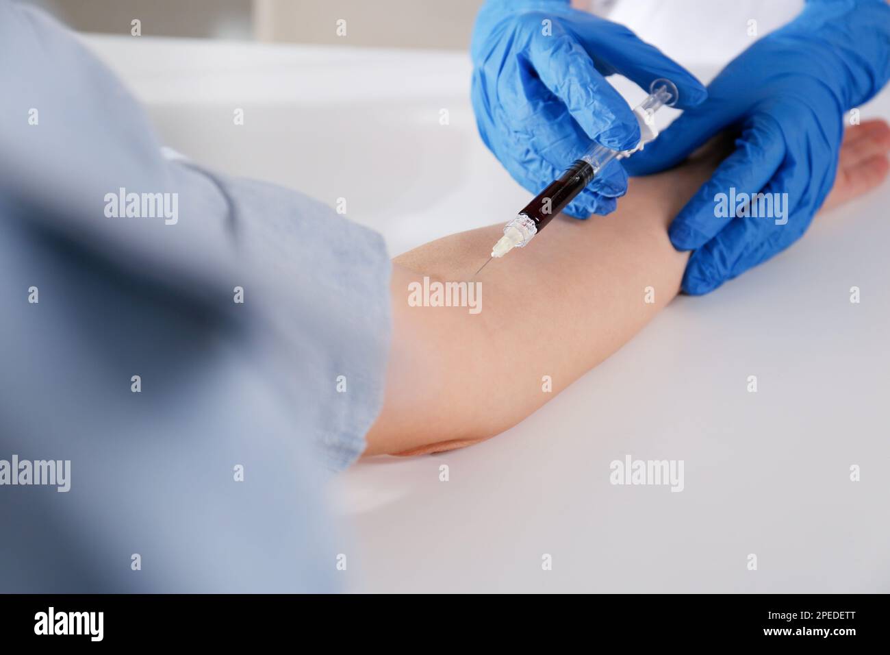 Nurse drawing blood sample from patient in clinic, closeup Stock Photo ...