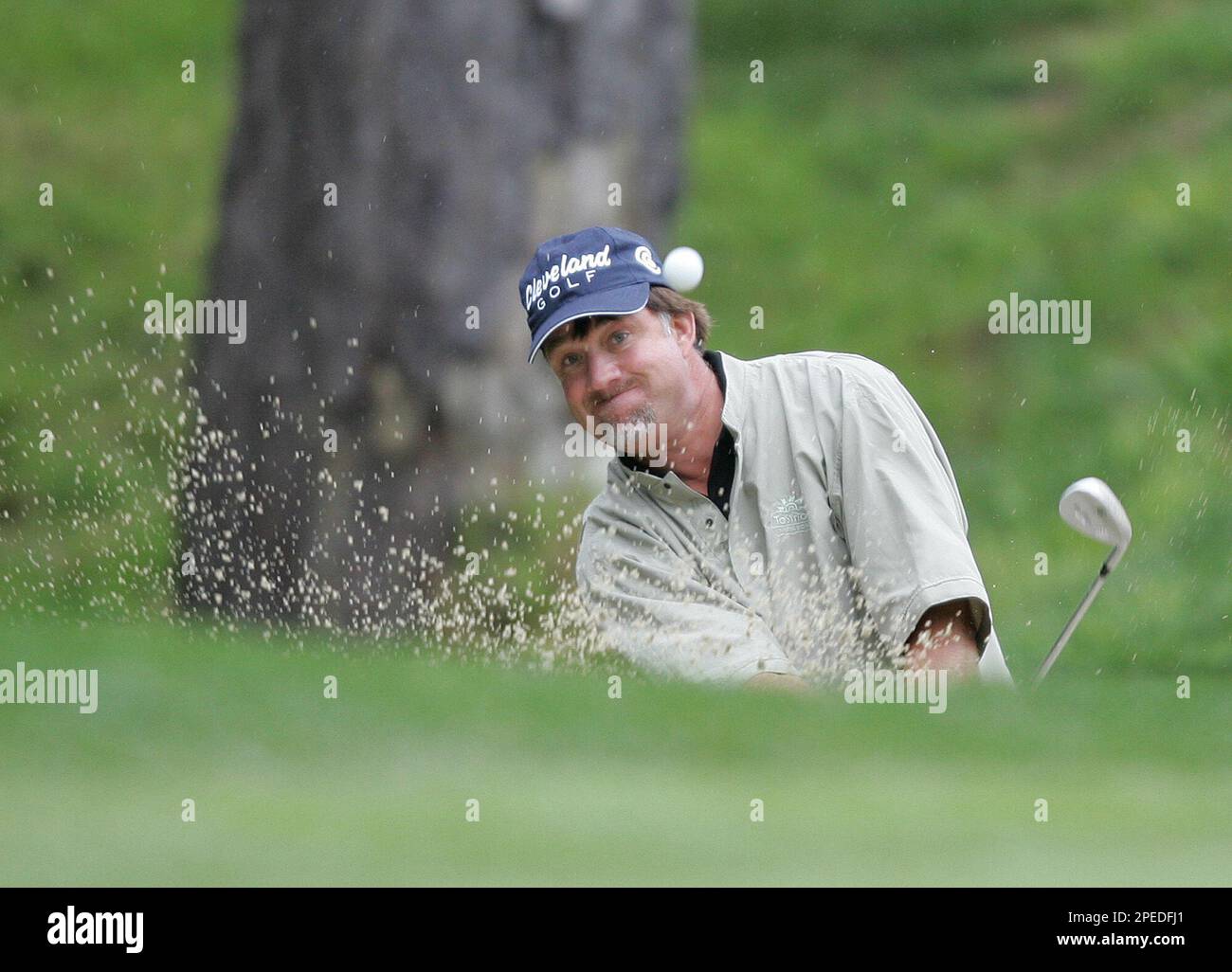 Andrew Magee blasts out of a sand trap on the 16th hole at the Spy Glass Hill Golf Course during ...