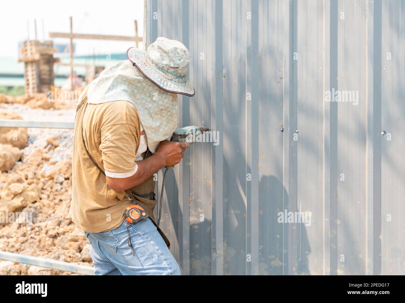 Fastening of a metal sheet to a framework of a fence screw-driver ...