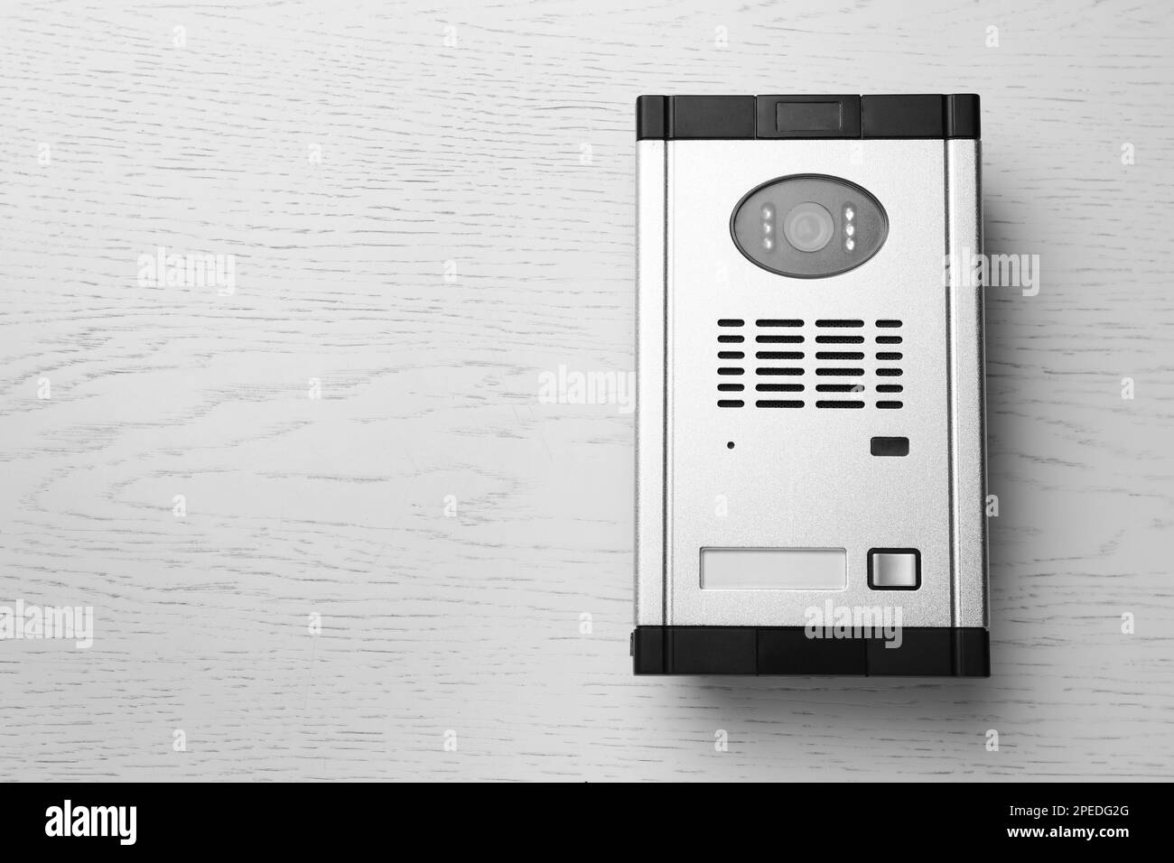 Door station of modern intercom on white wooden surface, top view ...