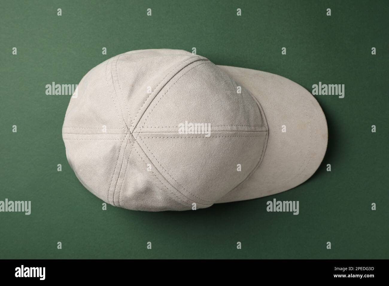 Stylish beige baseball cap on dark green background, top view Stock ...