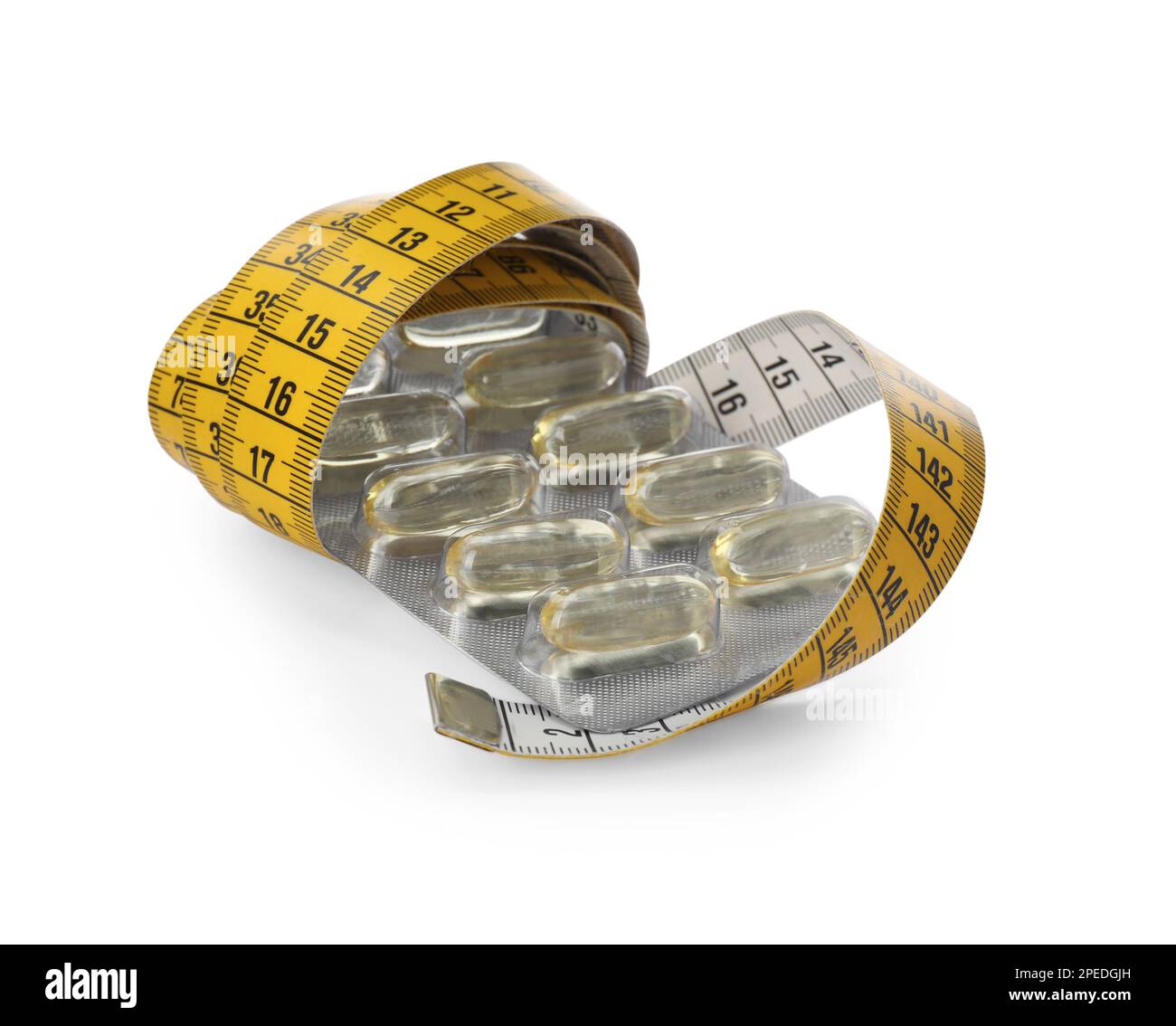 Oil capsules and measuring tape on white background. Weight loss Stock ...