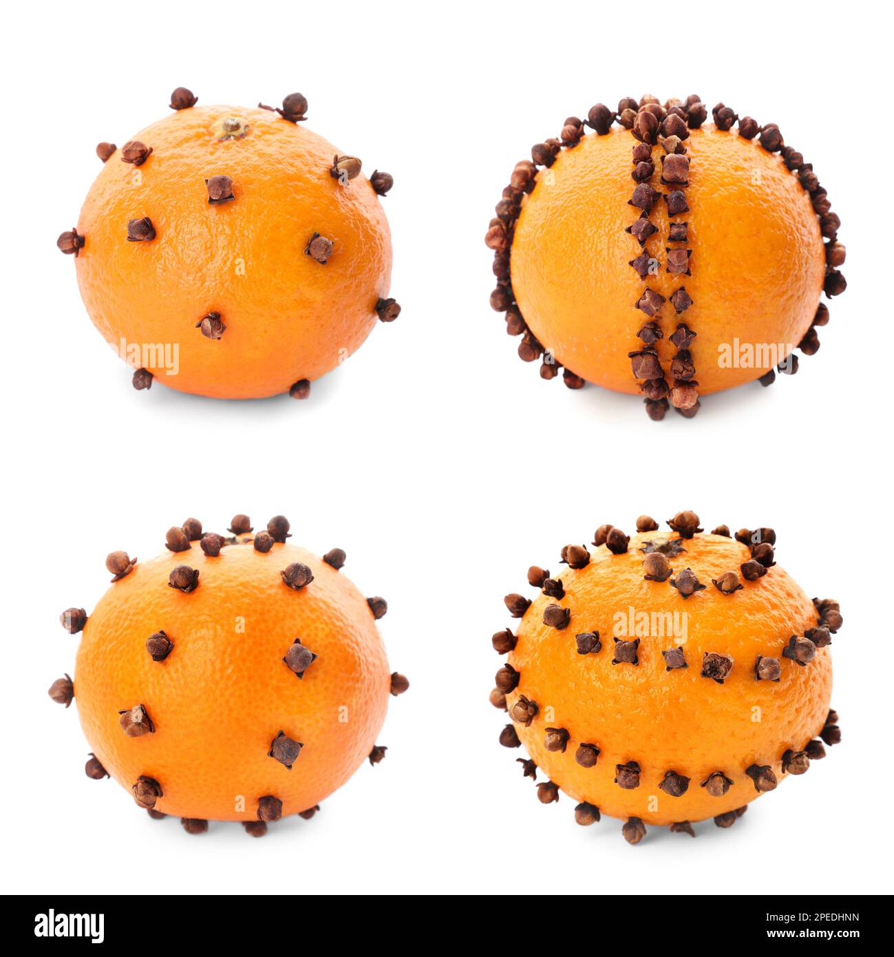 Set with pomander balls made of tangerine and cloves on white ...