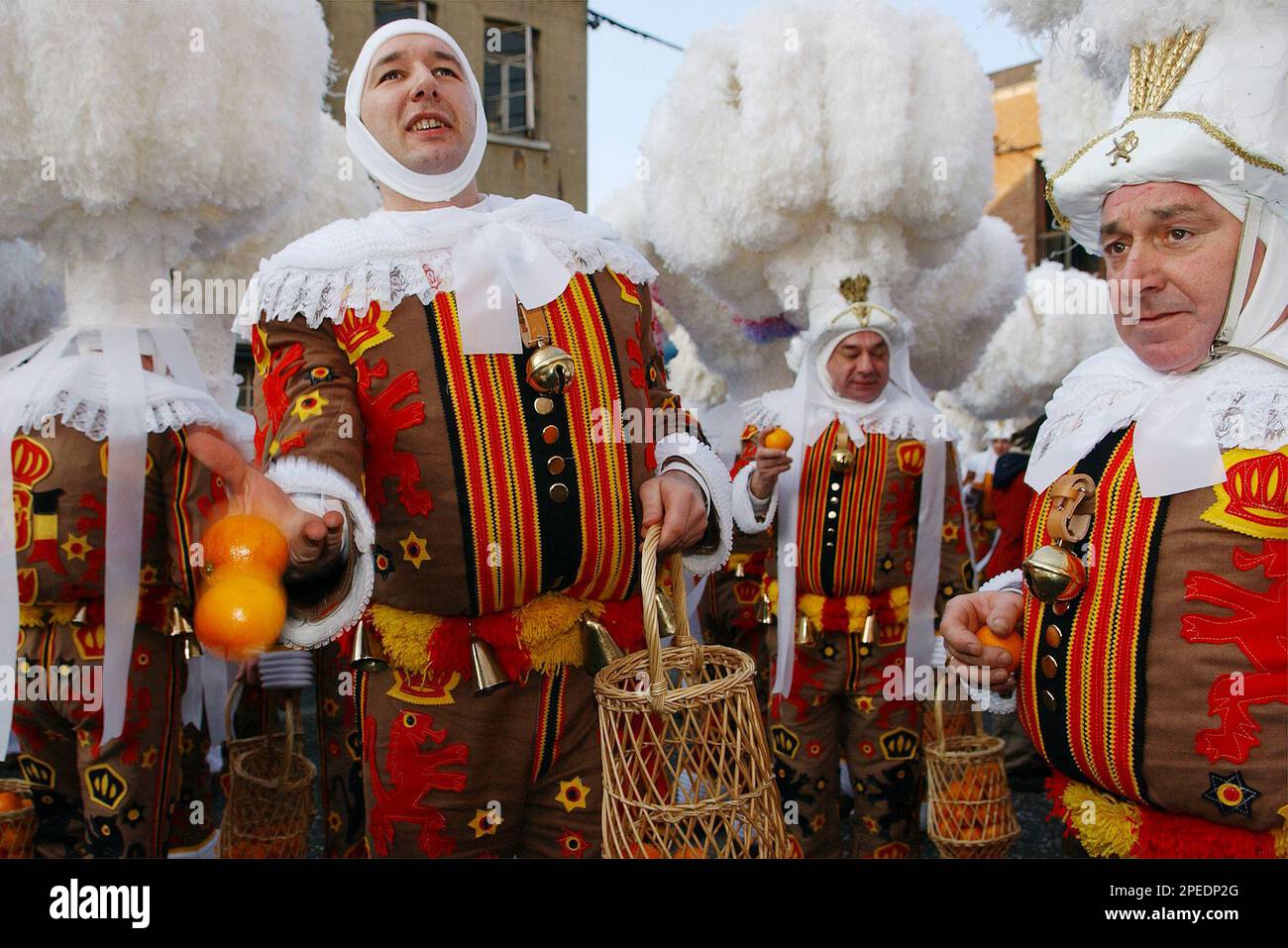 'Les Gilles de Binche' throw oranges to the public as they celebrate ...