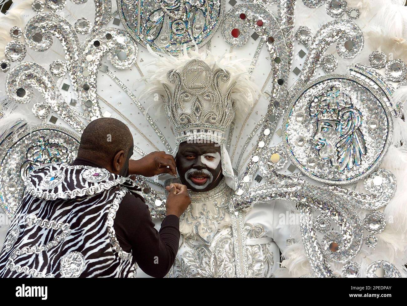 Zulu King Isaac Spencer Wheeler gets help with his head piece from ...