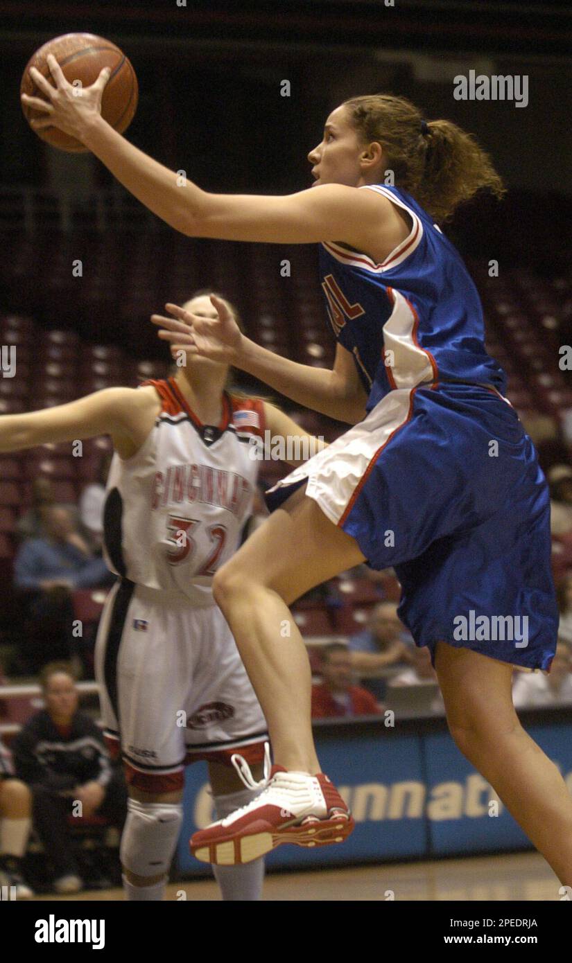 DePaul guard Jenna Rubino, right, goes up for a shot past Cincinnati ...