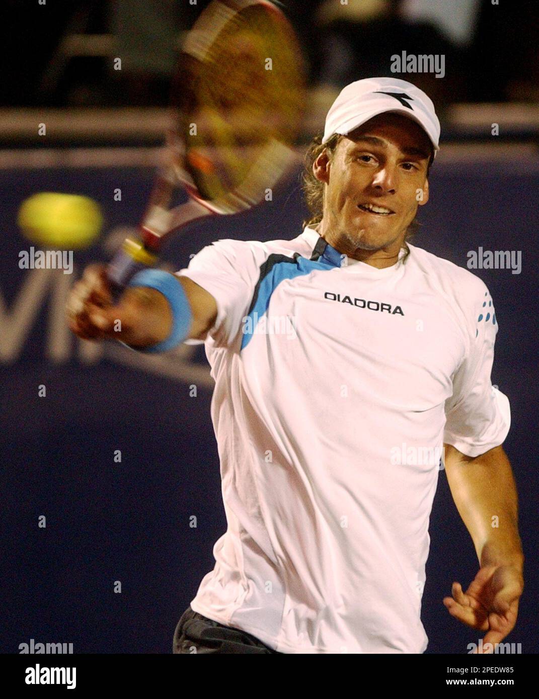 Argentina's tennis player Gaston Gaudio returns the ball to Chile's ...