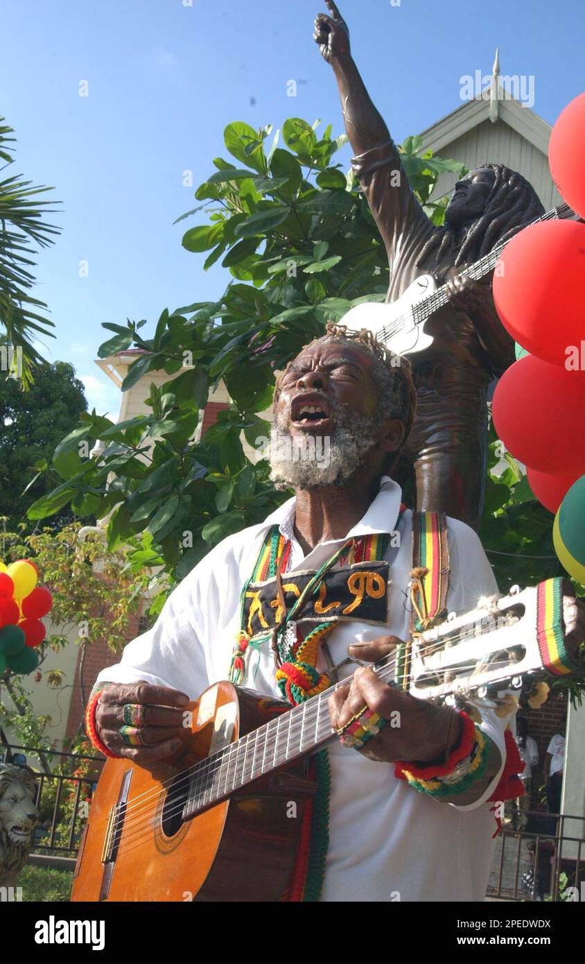Noel Campbell, a fan of the late Bob Marley, plays his guitar below a ...