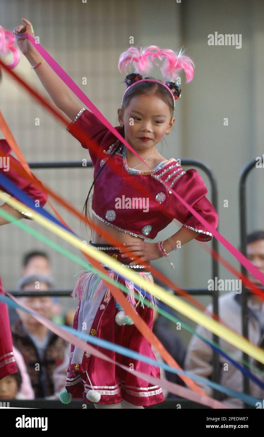 Tiffany Tran, 7, performs a "Chicken" dance as she wears a traditional ...