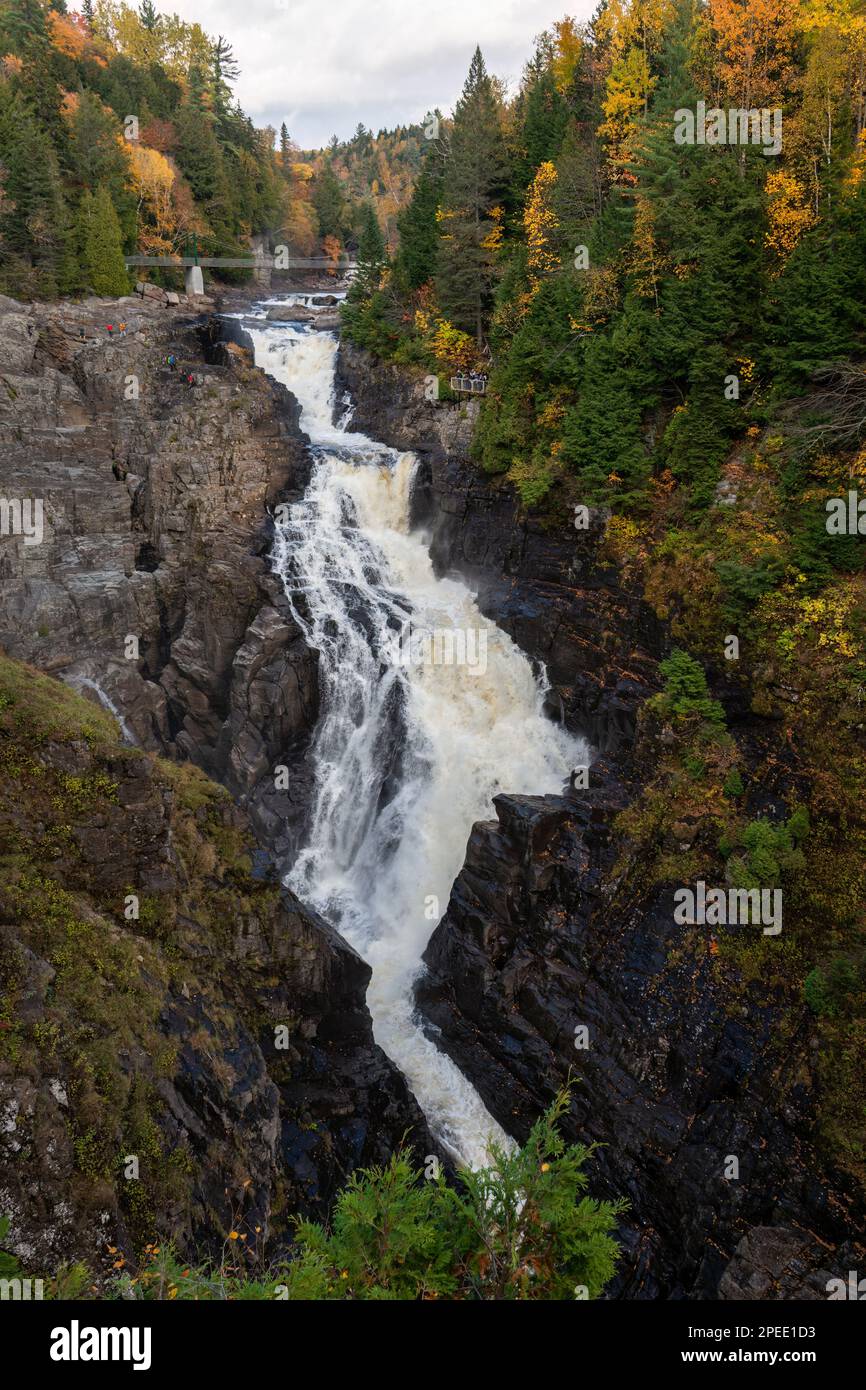 Waterfalls cascading down the Canyon Sainte-Anne. Suspension bridge in ...