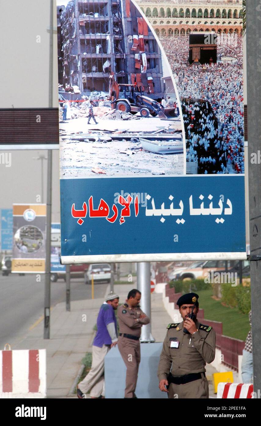 Saudi police officer walks beneath an anti terrorism poster in Riyadh ...