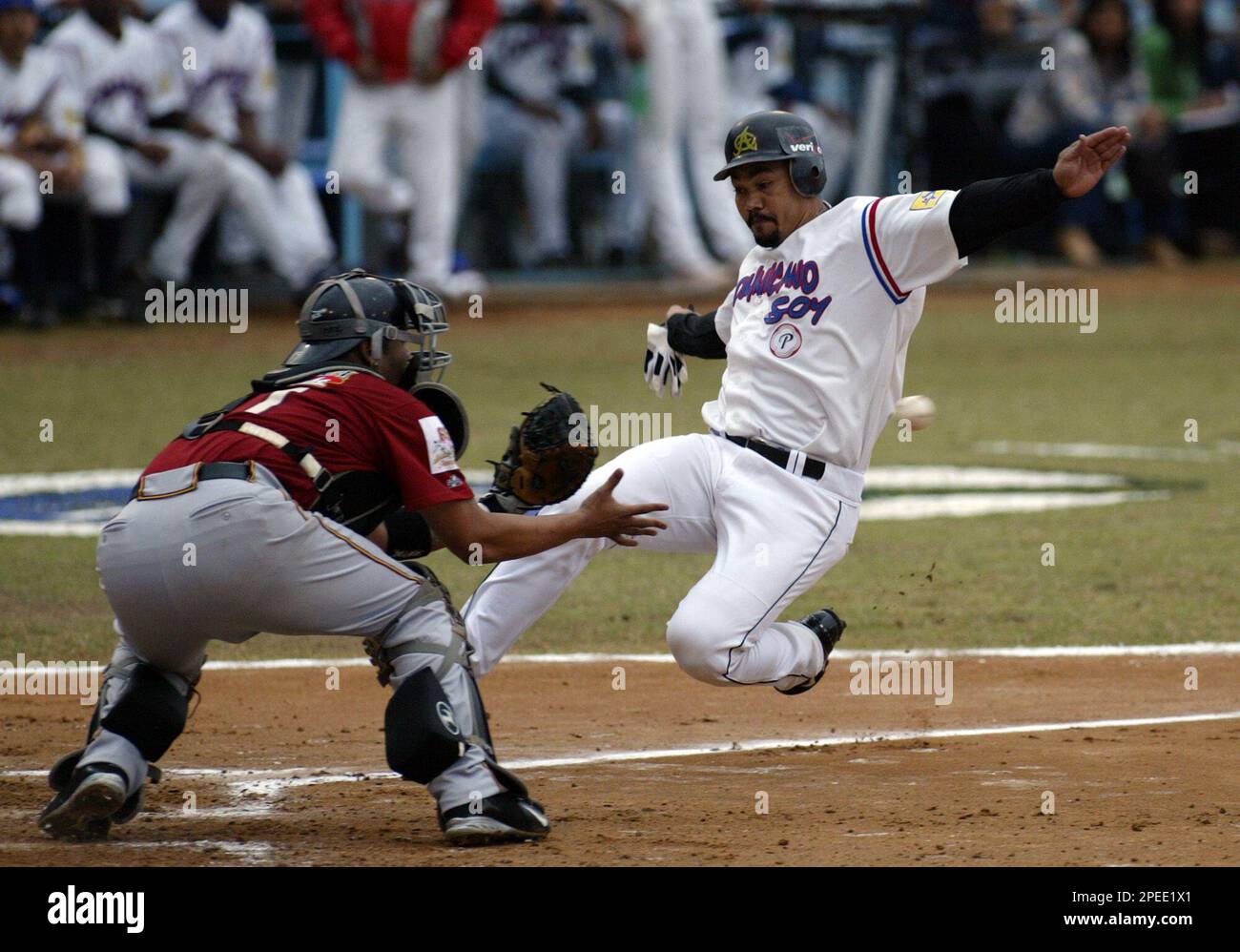 Aguilas Cibaenas'Alberto Castillo, righ, slides into home plate as ...