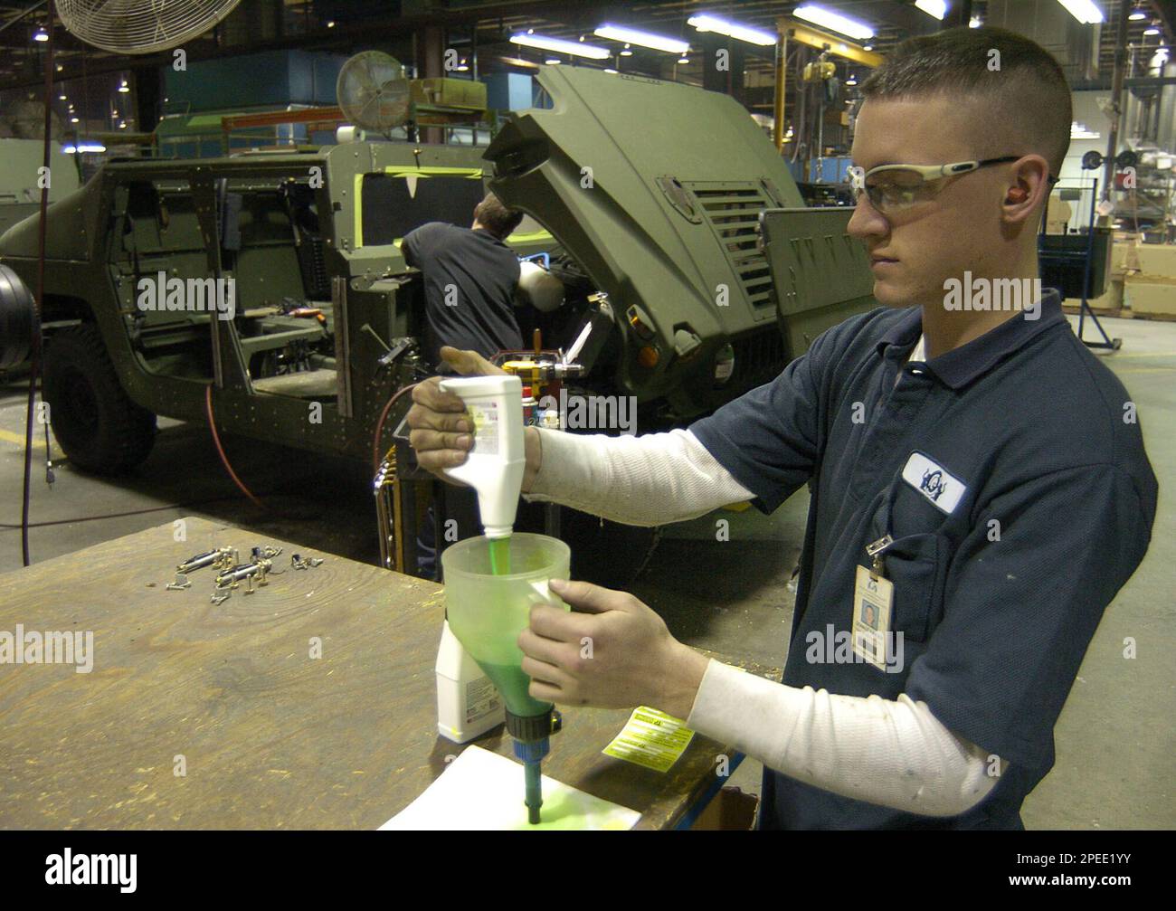 Armour Holdings' employee Donald Meier measures compressor fluid to be ...