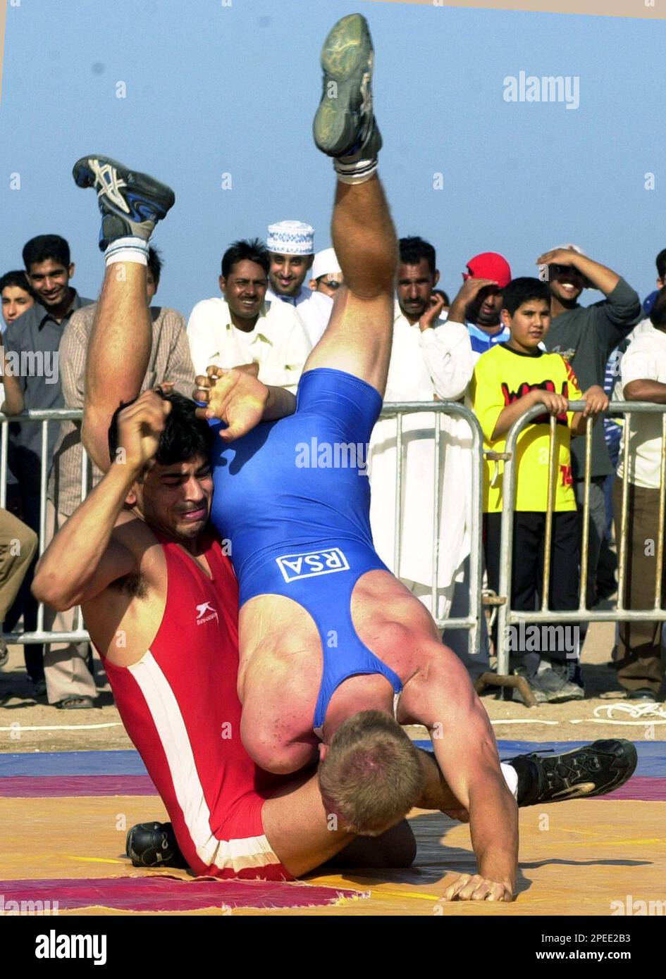 India's Naveen, left, wrestles with South African Etienne Van Hllysteen ...