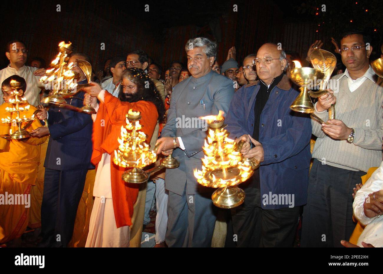 Hindu holy man Swami Chidanandaji Saraswati, in saffron robe, offers ...