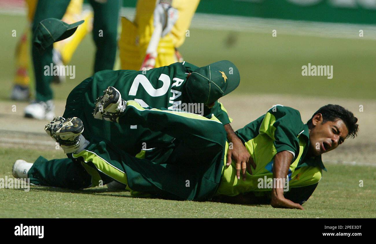 Pakistan's Rana Naved-ul-Hasan, left, and Mohammad Khalil collide while ...