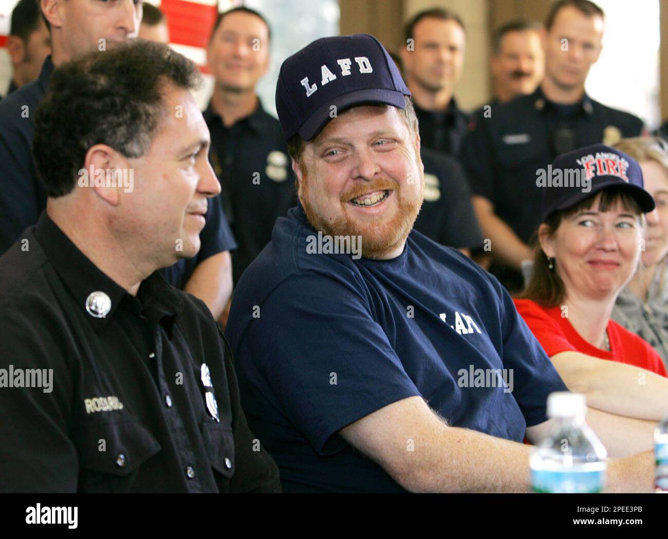 John Phipps, center, looks at Los Angeles Fire Dept. Capt. Bob Rosario ...