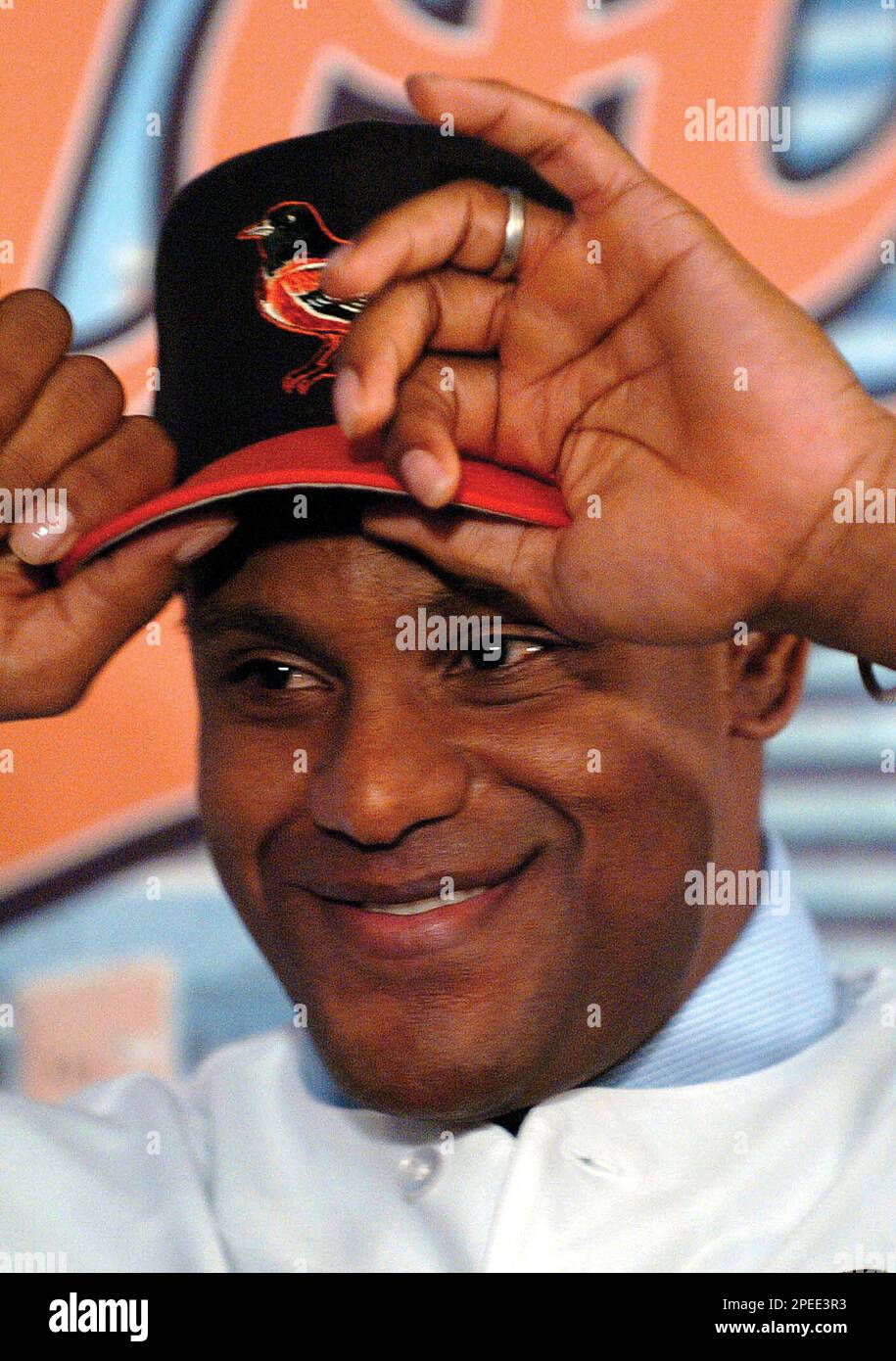 The Baltimore Oriole Sammy Sosa secures his hat after signing with the ...