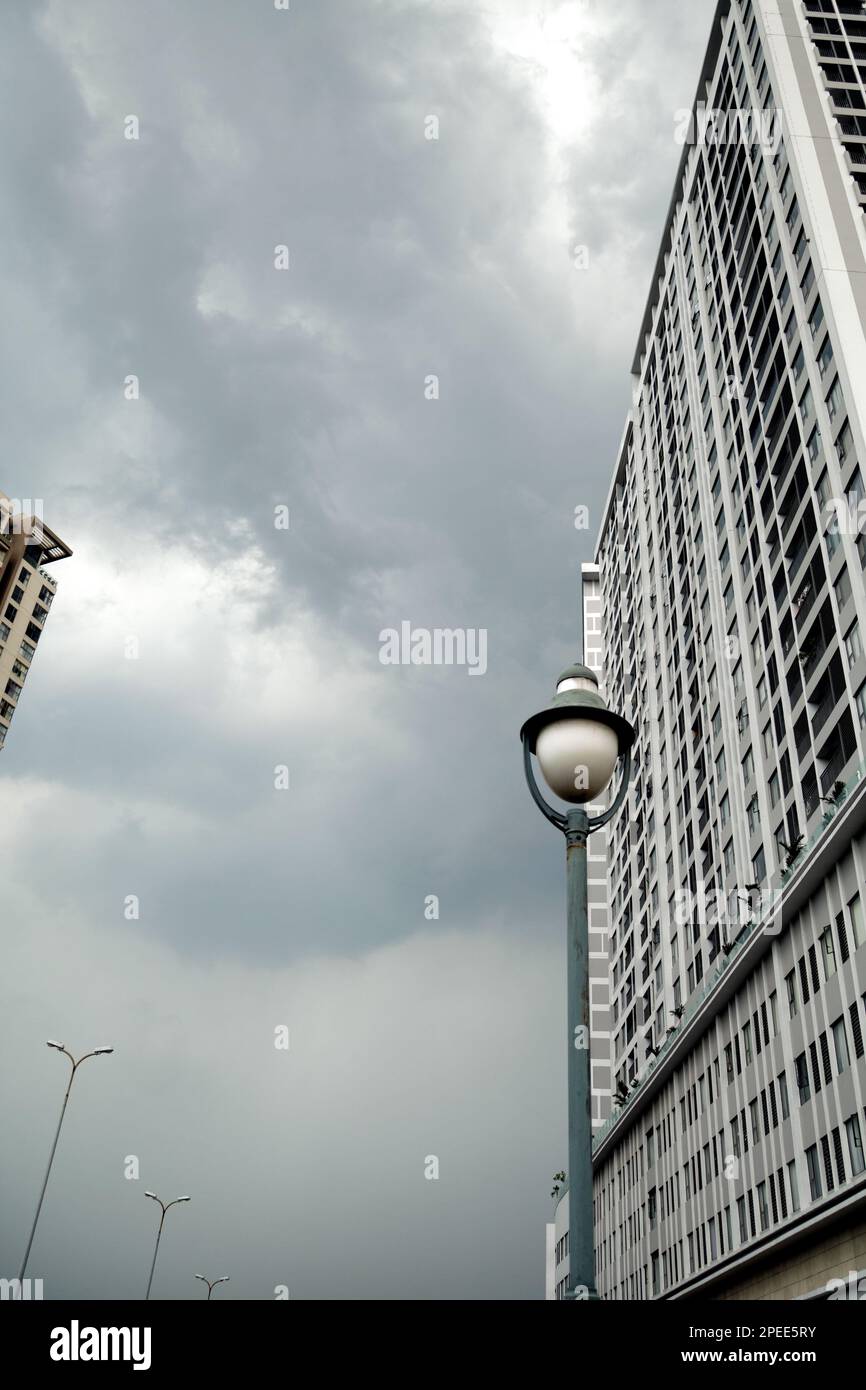 Tall gray buildings and lanterns in a city business district. Dull ...