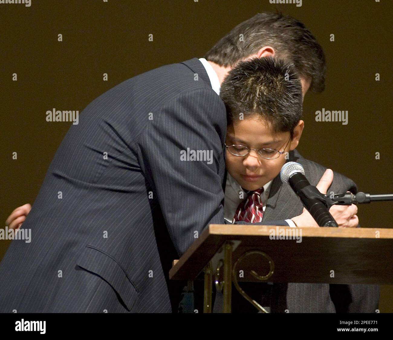 Shiloh Edsitty gets a hug from the Rev. Ray Giunta after Edsitty spoke ...