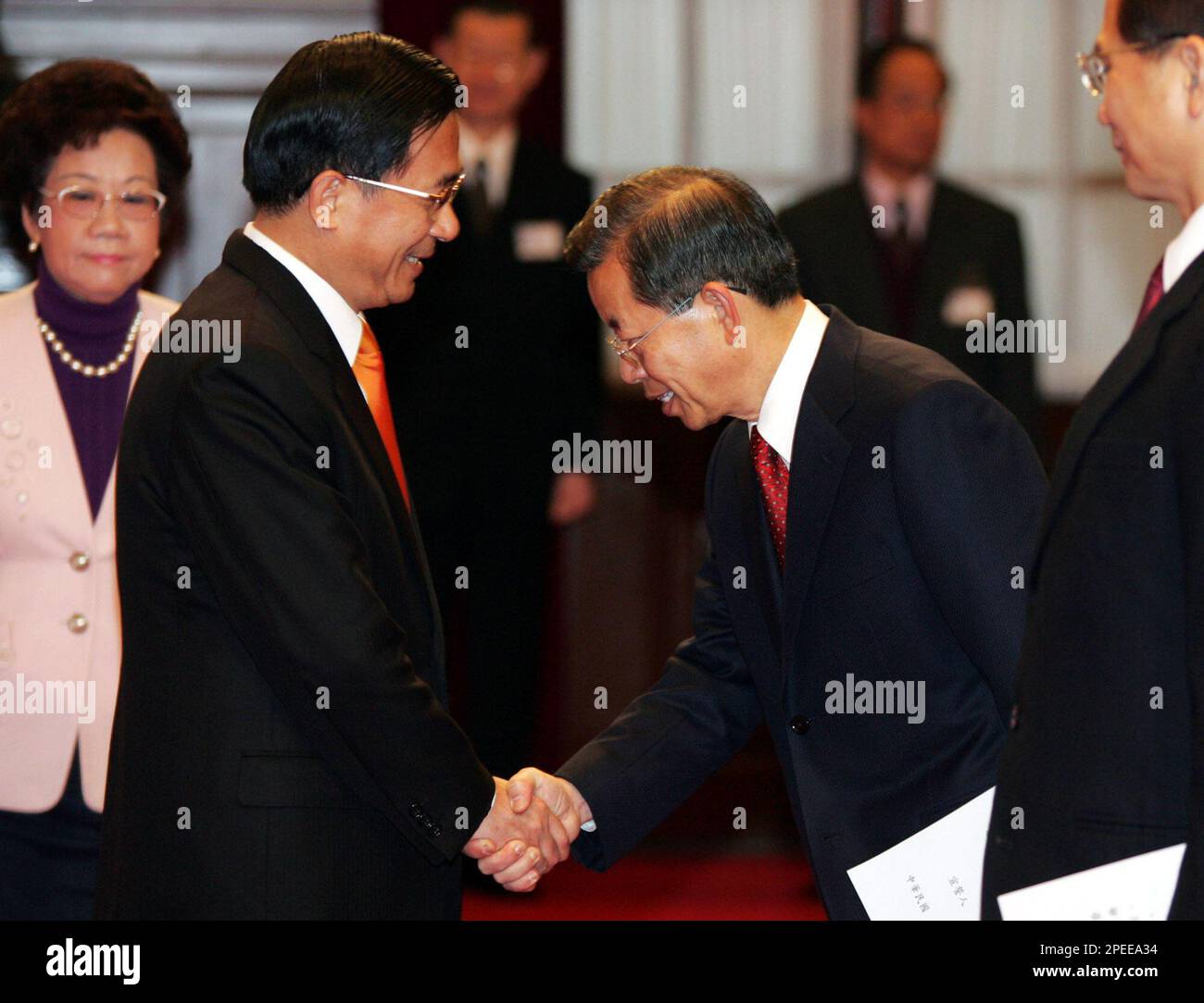 New Taiwan Premier Frank Hsieh, second from right, bows and shakes ...