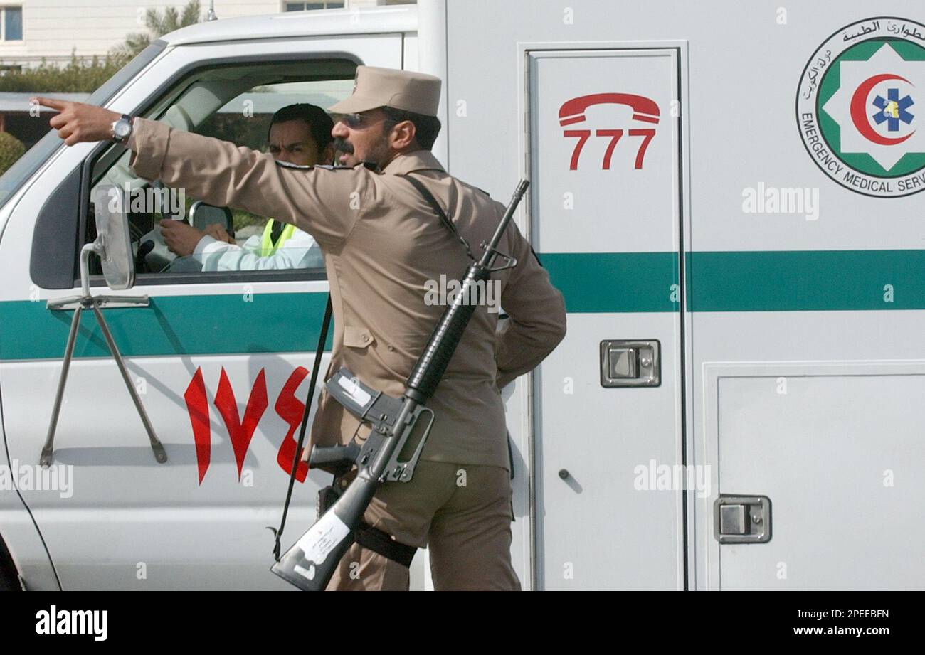 A Kuwaiti policeman directs an ambulance during the gunbattle in ...