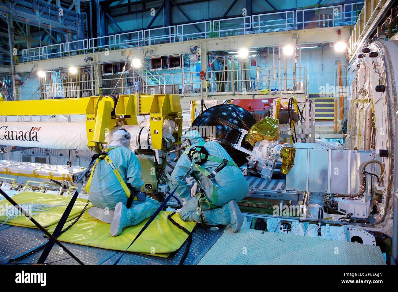 In this undated photo released by NASA, workers at the space agency's Orbiter Processing ...