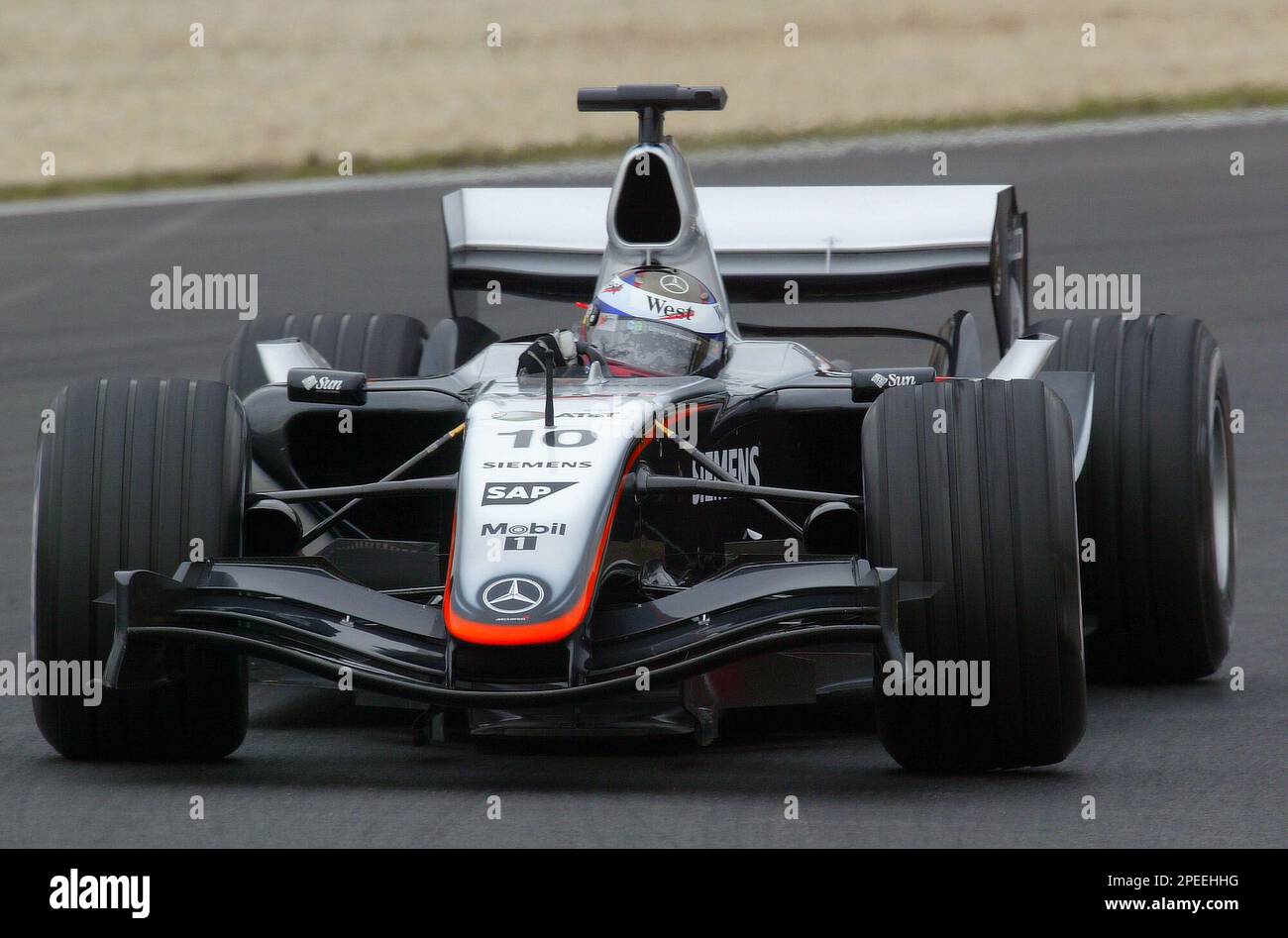 Colombian Formula One driver Juan Pablo Montoya takes a curve with the ...