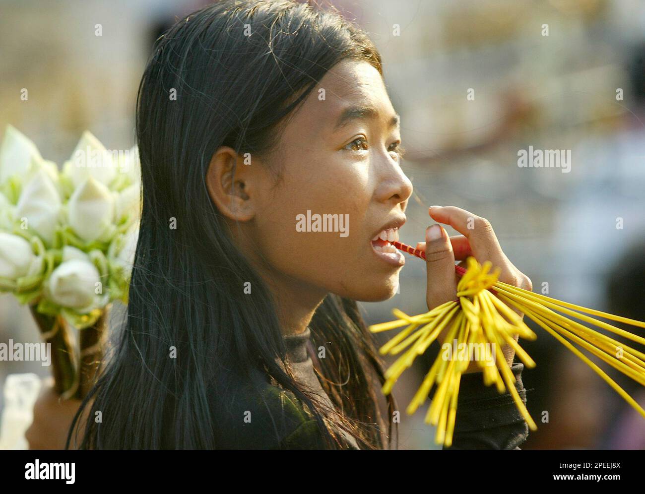 Holding lotus flowers in one hand, and chewing incense sticks in the ...