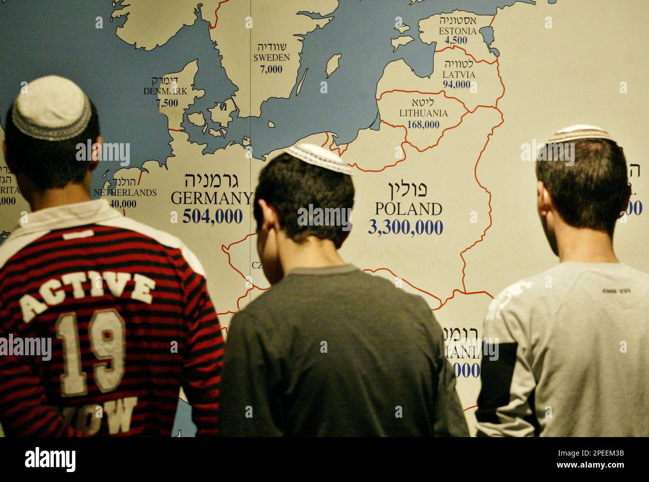 Jewish students look at a map showing the numbers of Jews living in ...