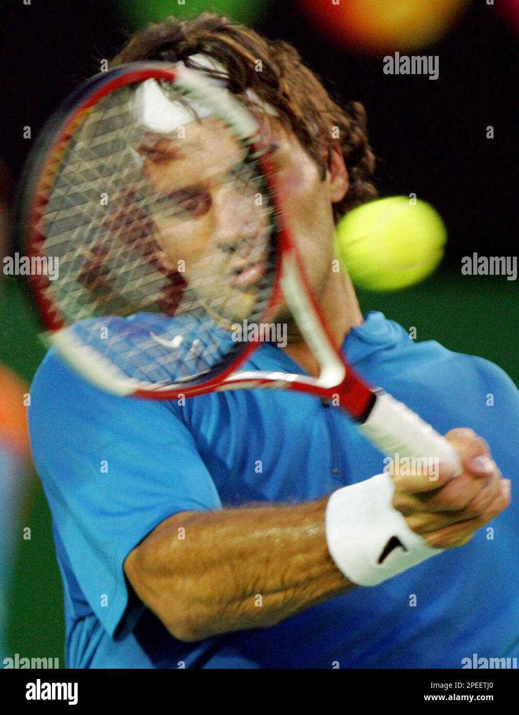 Roger Federer of Switzerland, top seed, makes a forehand return to ...