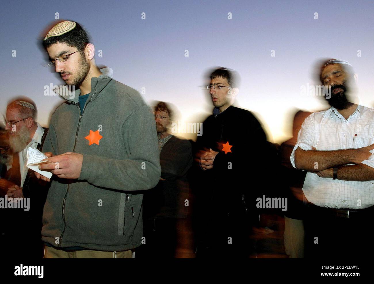 ** FILE ** Israeli settlers, some wearing orange Star of David patches ...