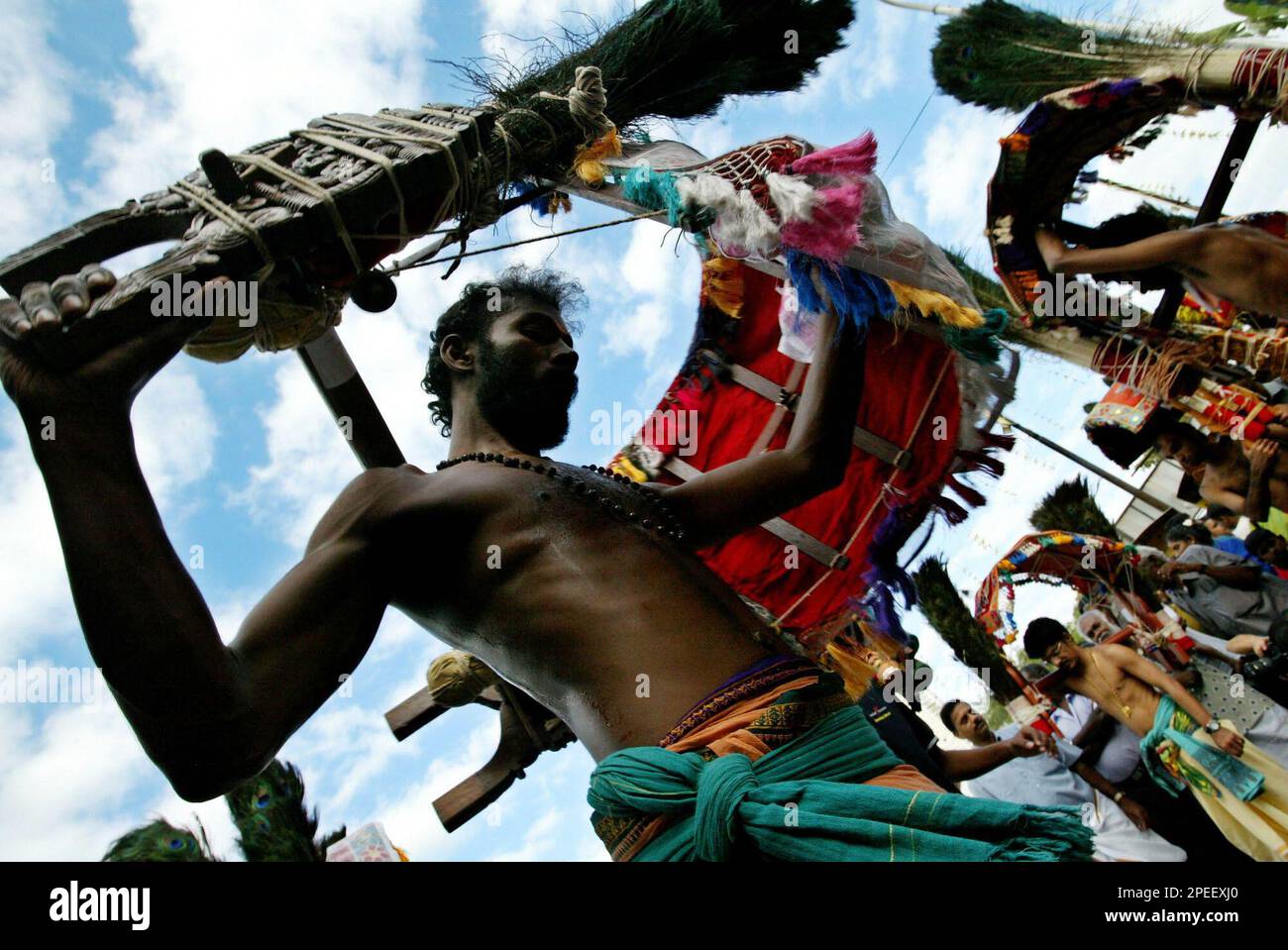 An Indian descent Malaysian dances as he carries a kavadi during a ...
