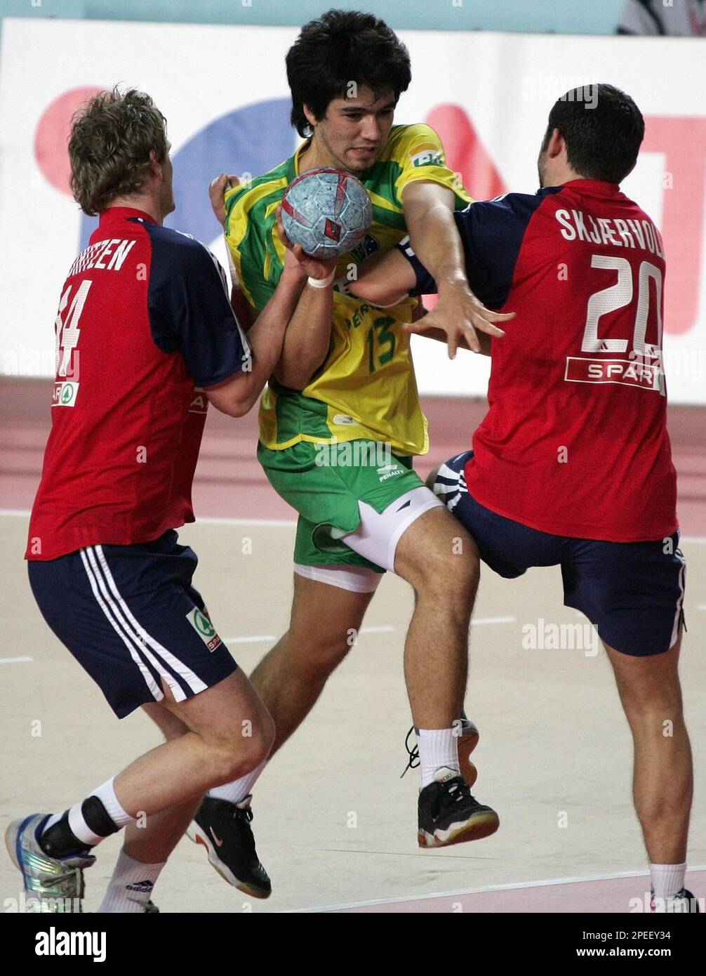 Brazil's Gustavo Cardoso, center, is attacked by Norway's Jan Thomas ...