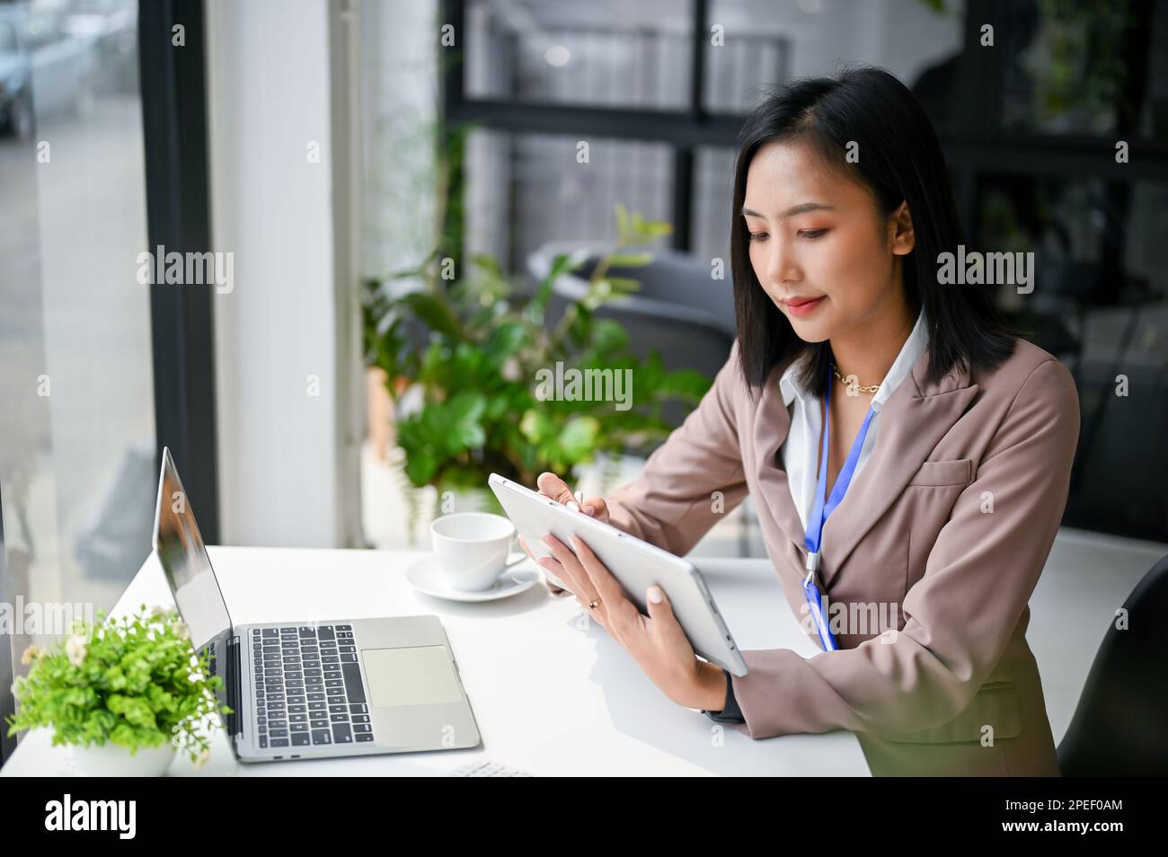 Attractive beautiful millennial Asian businesswoman or female banker ...