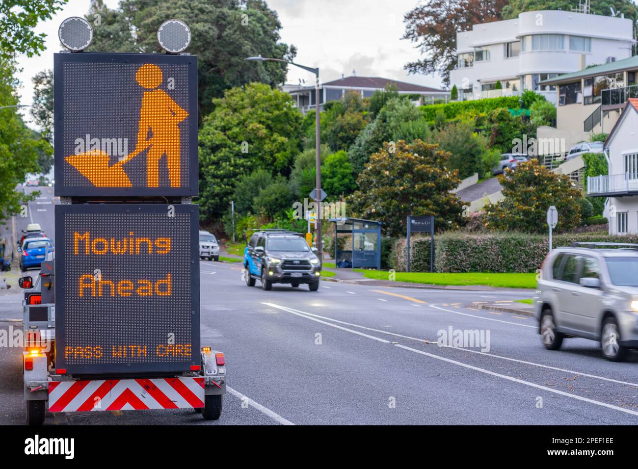 Mowing ahead LED warning sign in city street Stock Photo - Alamy