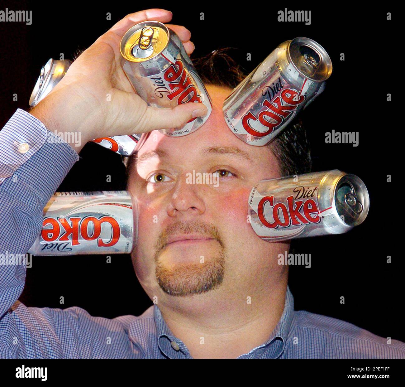Jeff Snodgrass shows how he can use suction to stick five soda cans to ...