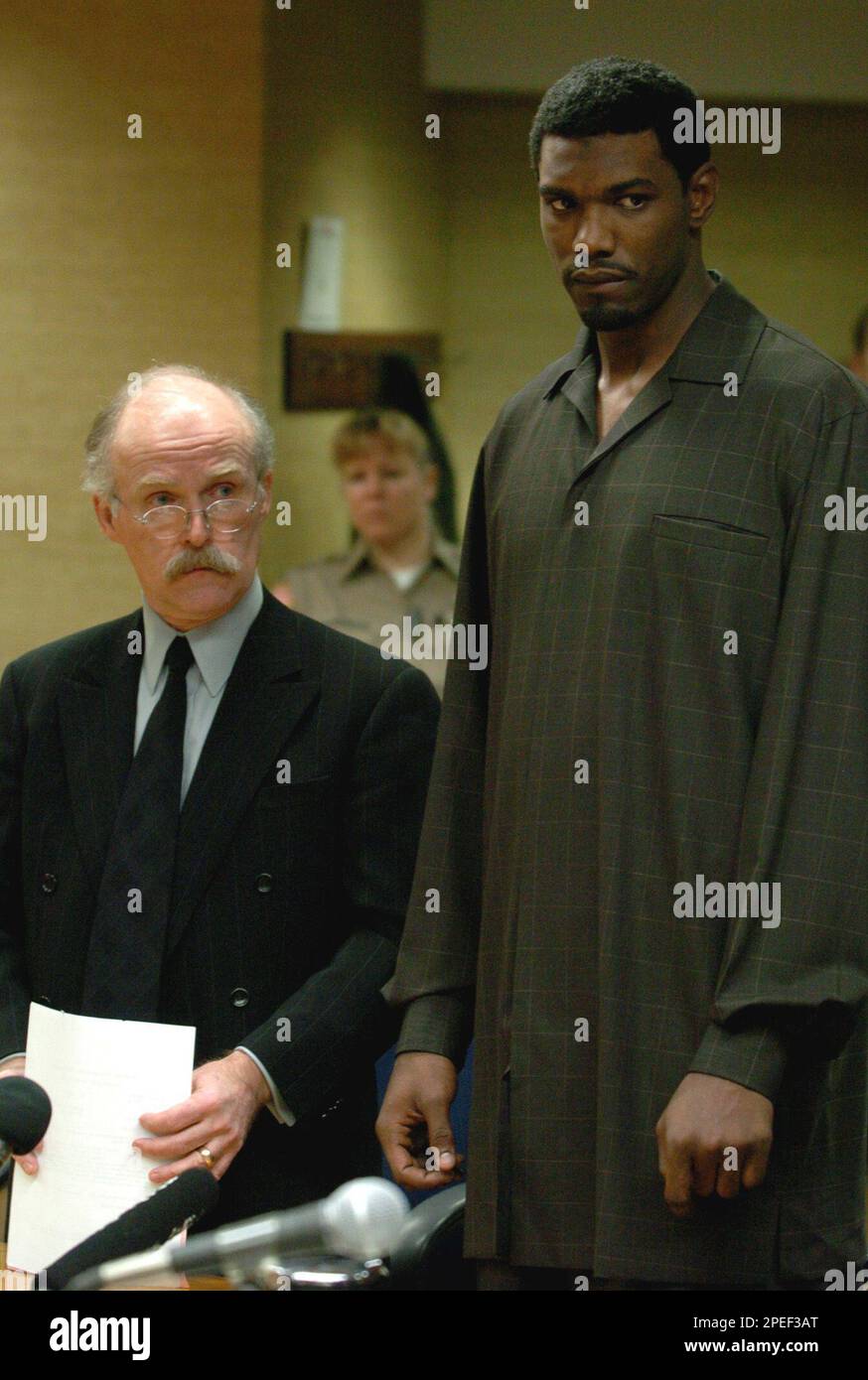 Portland Trail Blazers' Qyntel Woods, right, with his defense attorney ...