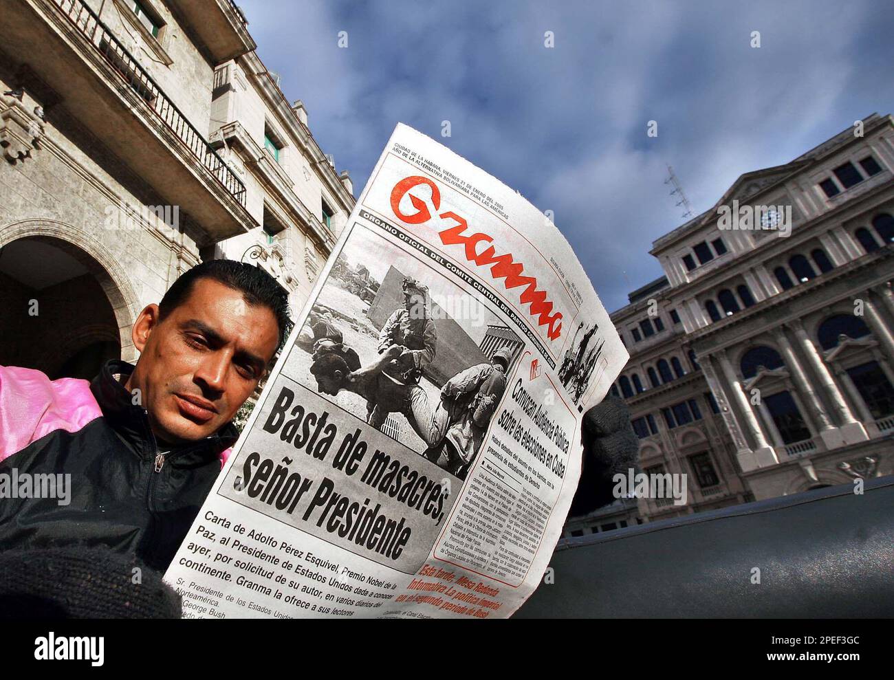 An unidentified carriage driver reads Granma Cuban official newspaper ...