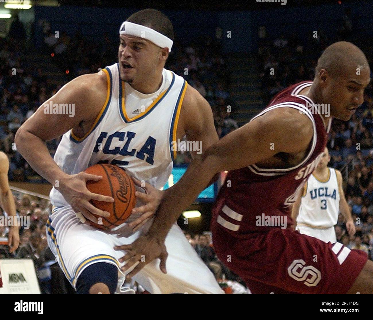 UCLA's Michael Fey, left, drives to the basket past Stanford's Rob ...