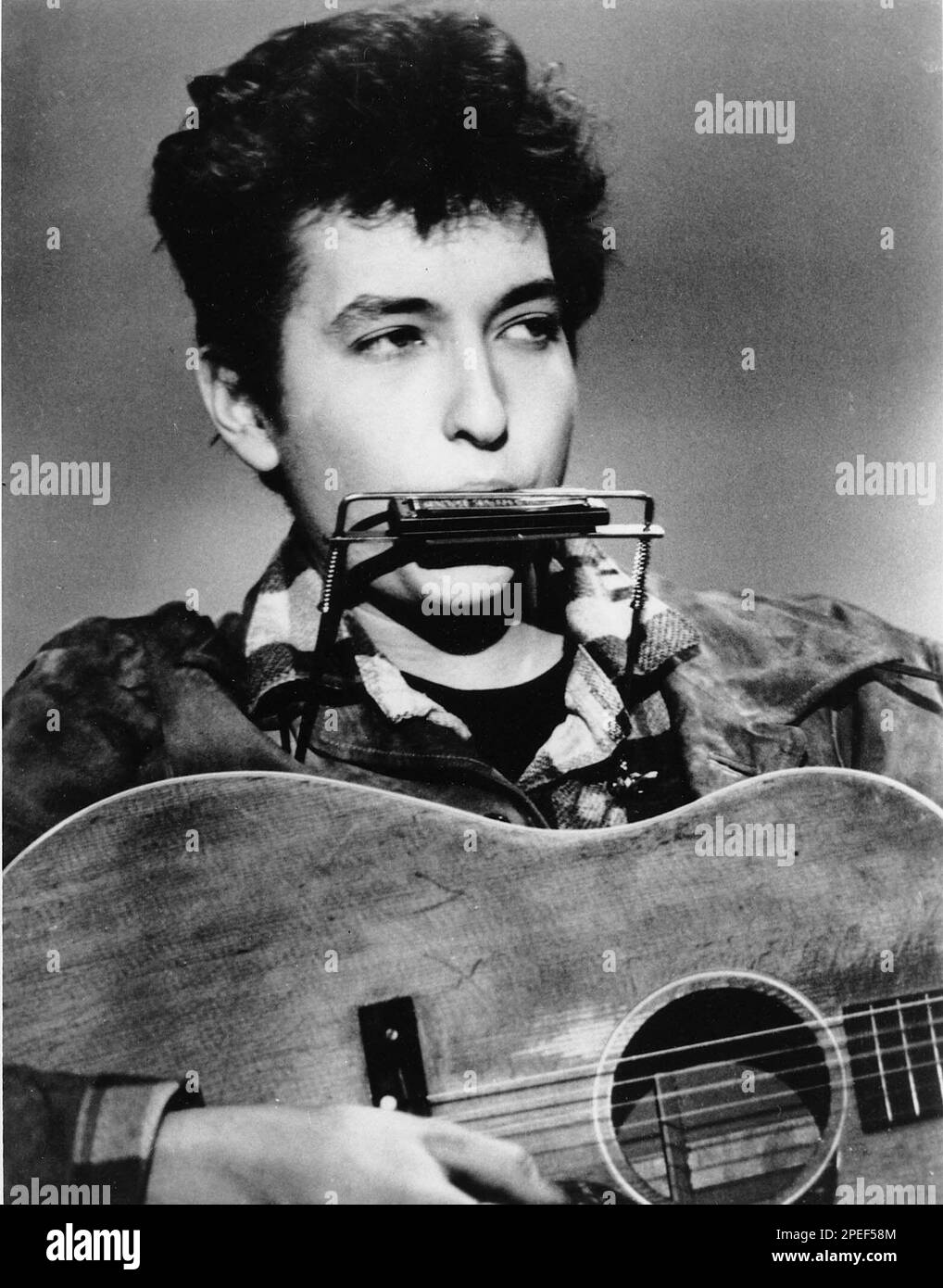 **FILE**Folk singer and songwriter Bob Dylan plays the harmonica and ...