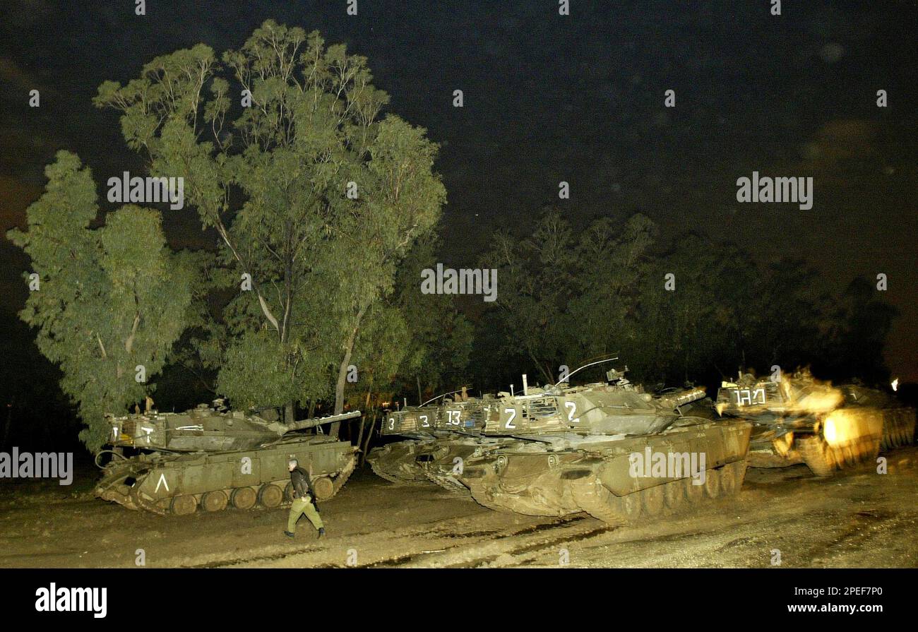 Israeli army tanks gather near Kibbutz Mefalsim on the edge of the ...