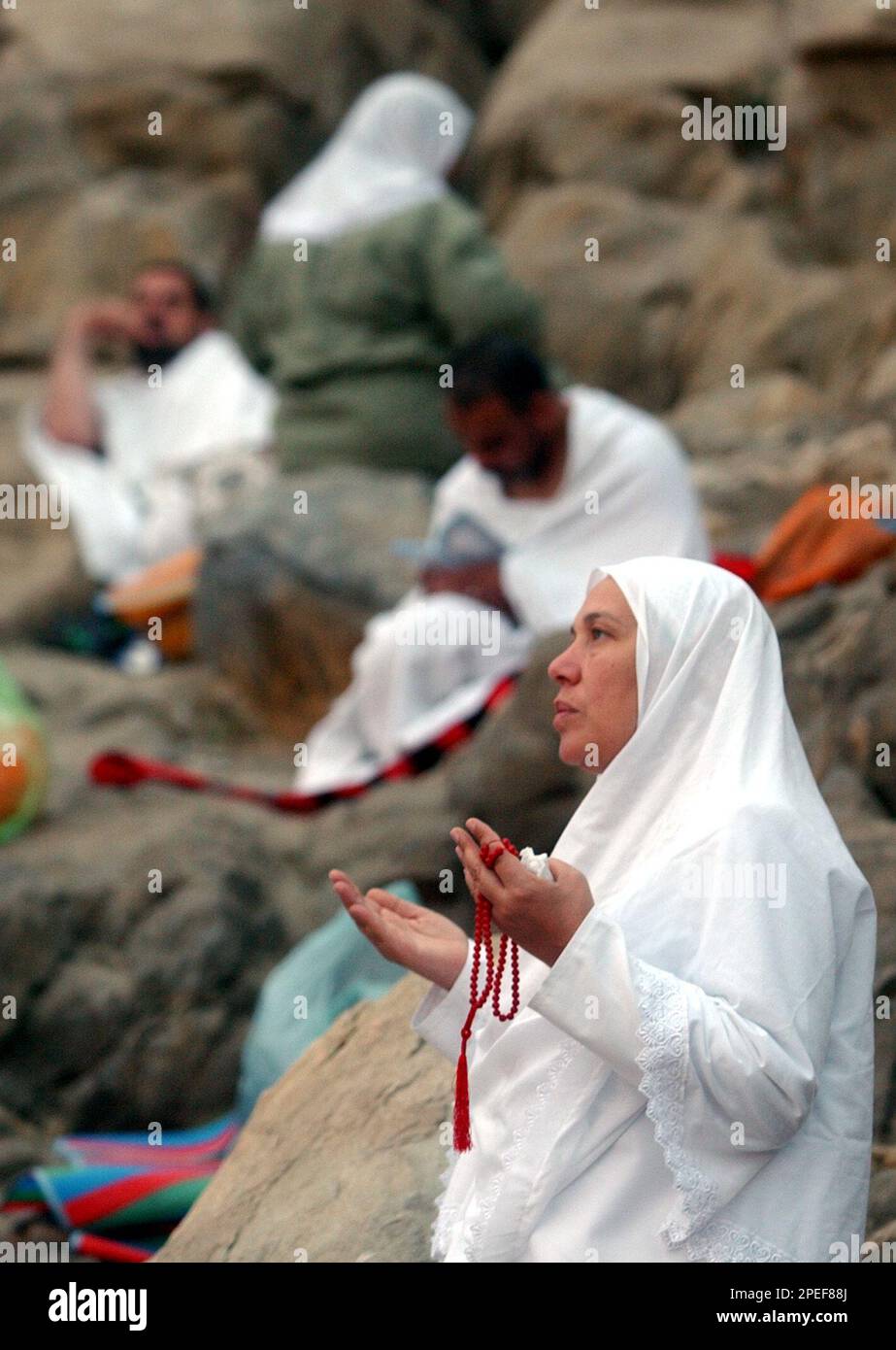 A pilgrim prays at Jabal Al Rahma holy mountain, the mountain of ...