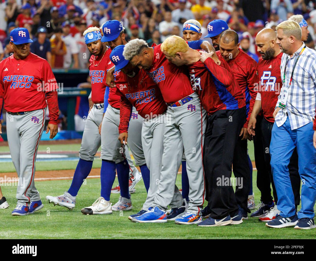 Puerto Rico pitcher Edwin Diaz (39) is helped by team pitching coach ...