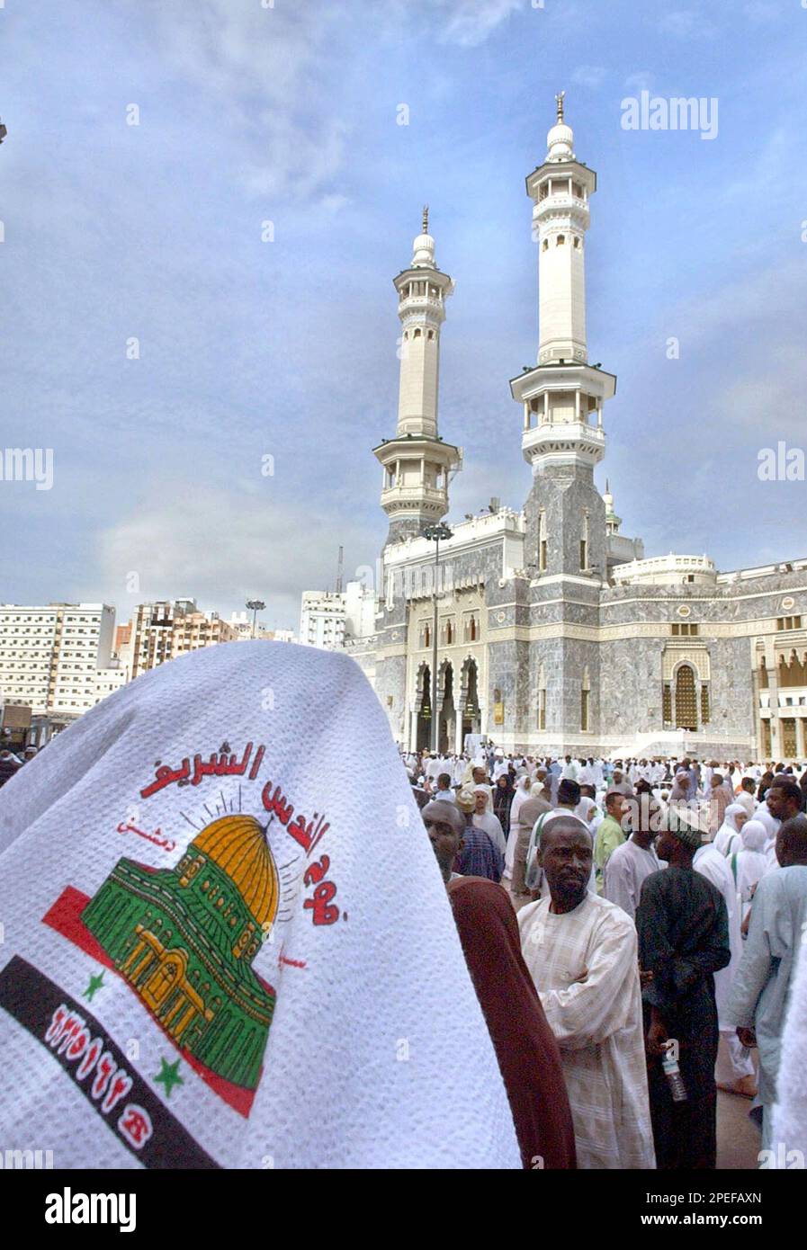 A Syrian veiled pilgrim, left, covered her head with scarf decorated ...