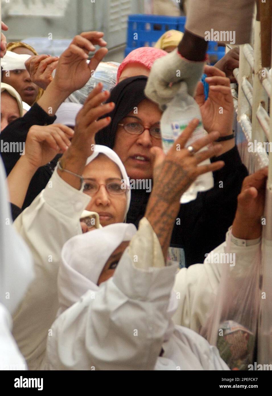 Pilgrims receive free water distributed by the Saudi government at the ...